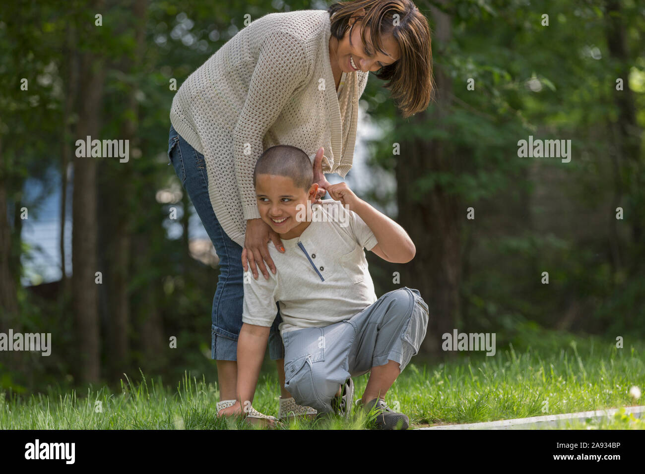 Hispanic boy with Autism playing outside with his mother Stock Photo ...