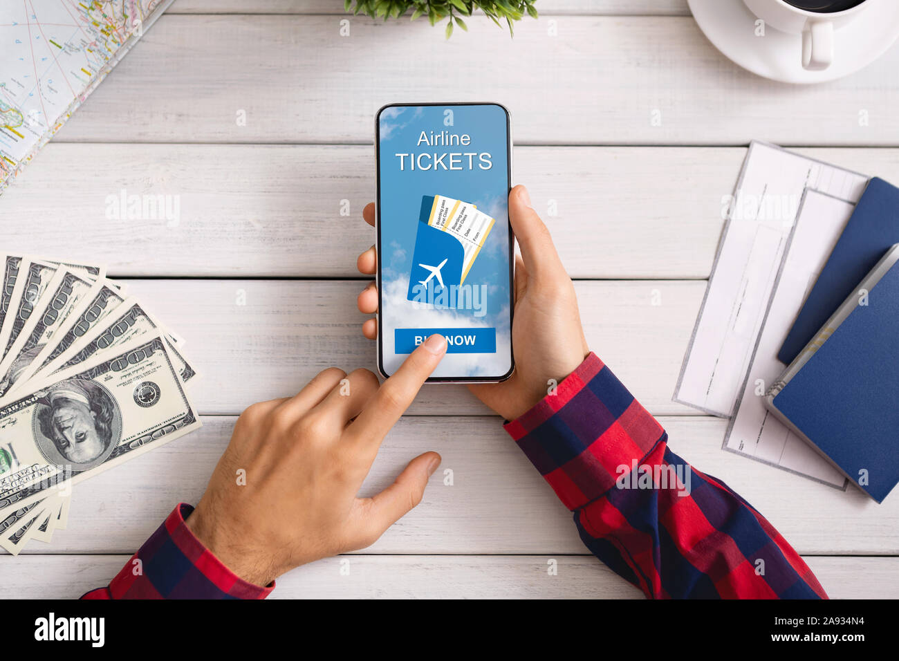 Man buying plane tickets online via application on smartphone Stock ...