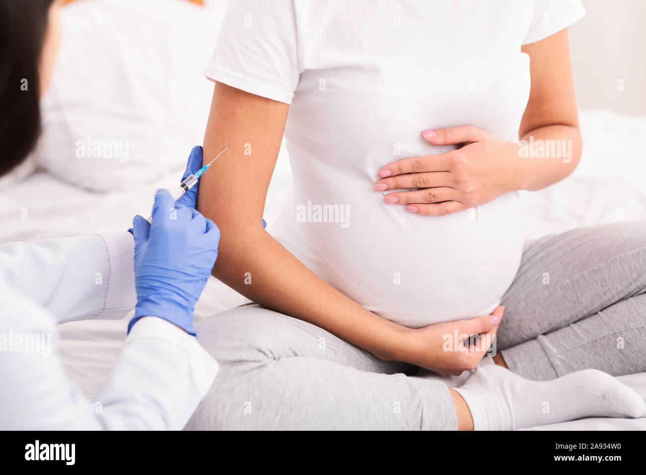 Unrecognizable Pregnant Lady Receiving Injection Sitting On Bed ...
