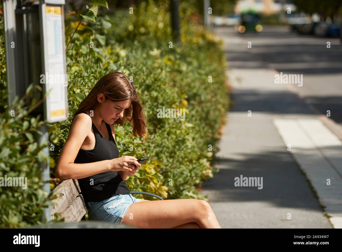 Sitting at bus stop hi-res stock photography and images - Alamy
