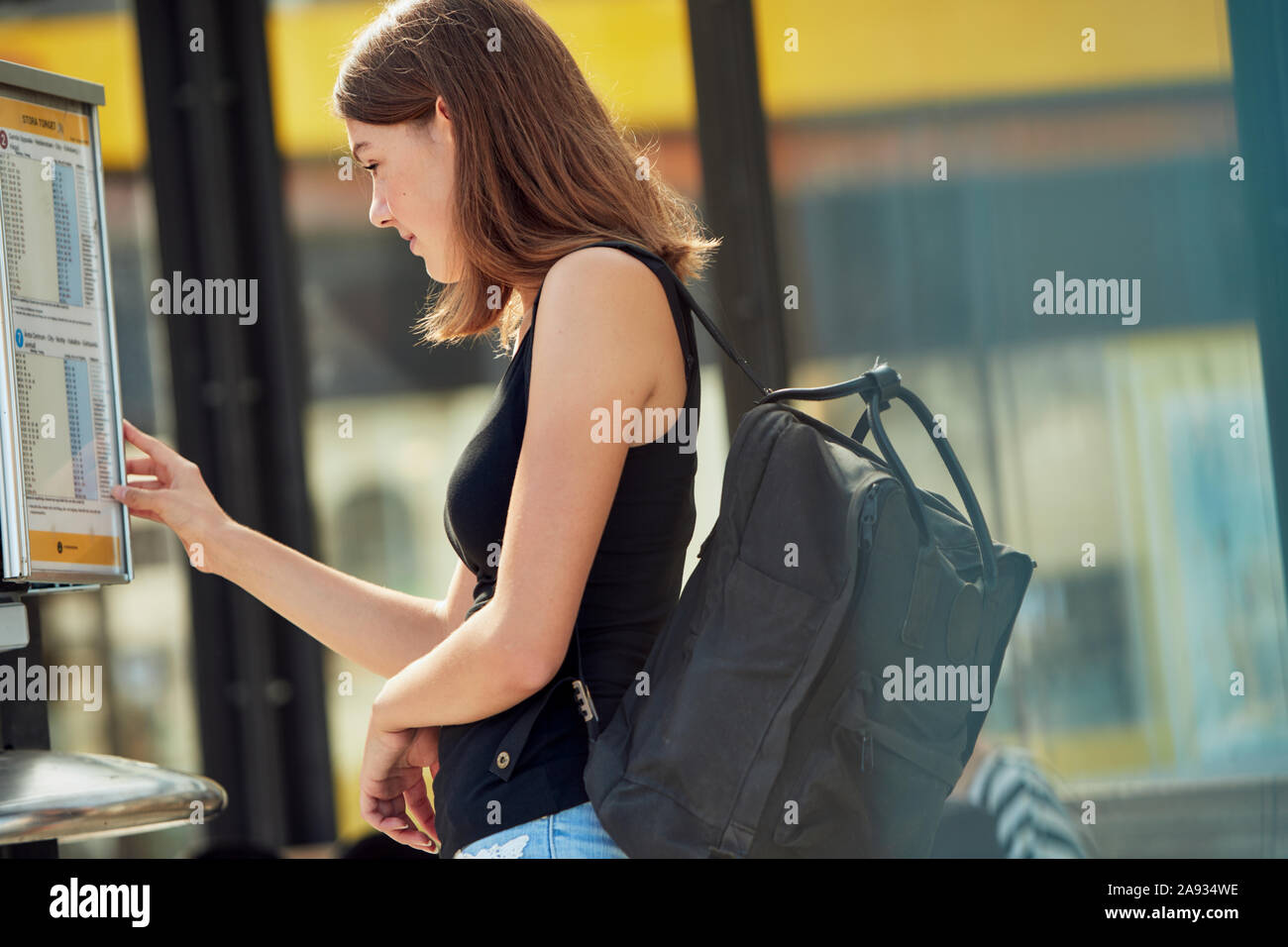 Woman checking timetable hi-res stock photography and images - Alamy