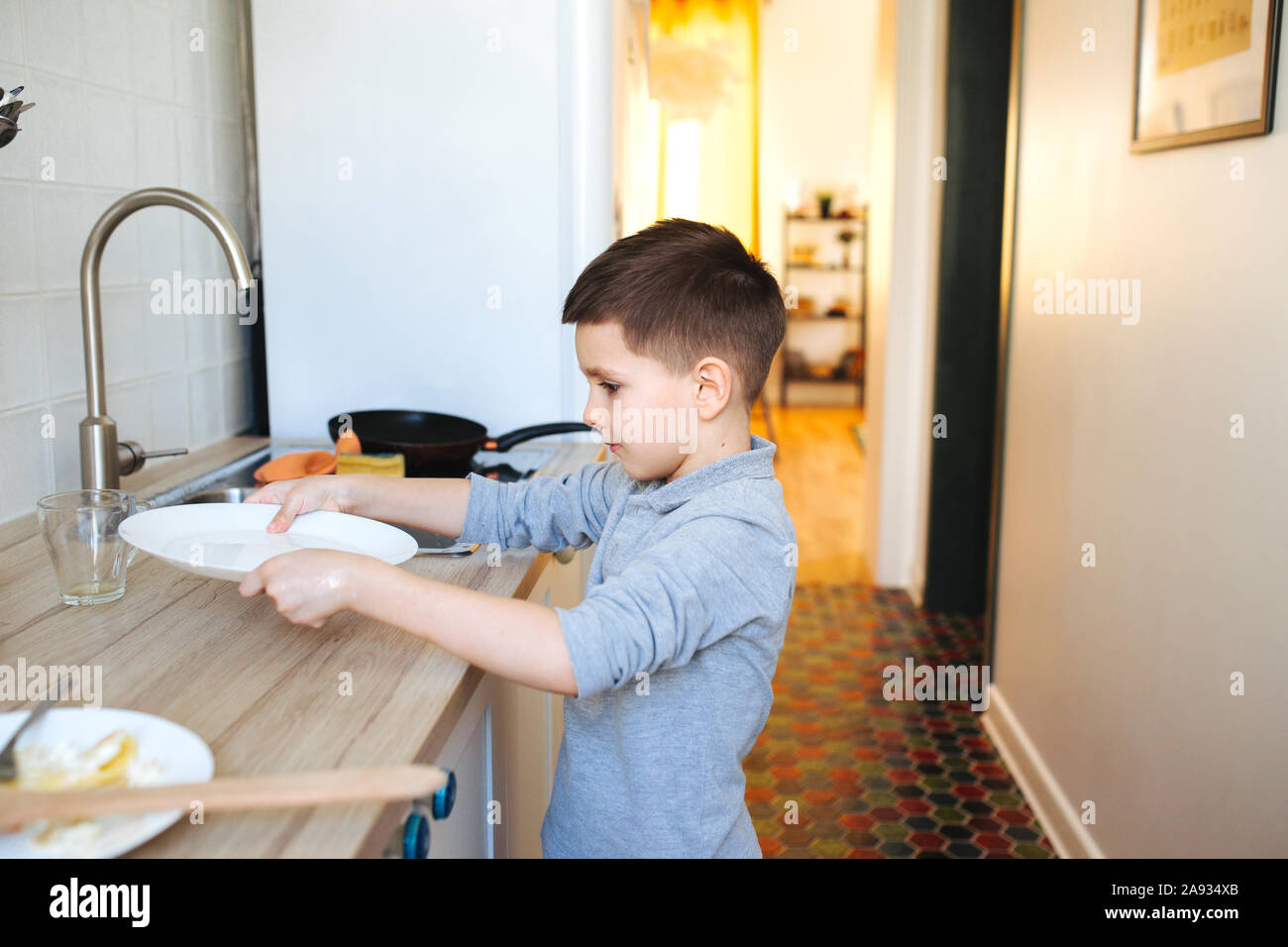 Boy washing dishes hi-res stock photography and images - Alamy