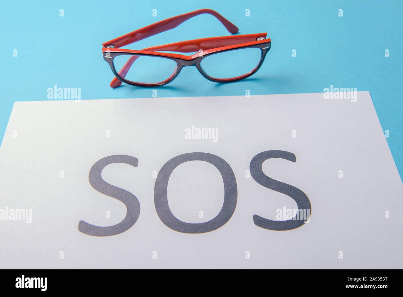 Word SOS written on white paper. Blue background Stock Photo - Alamy