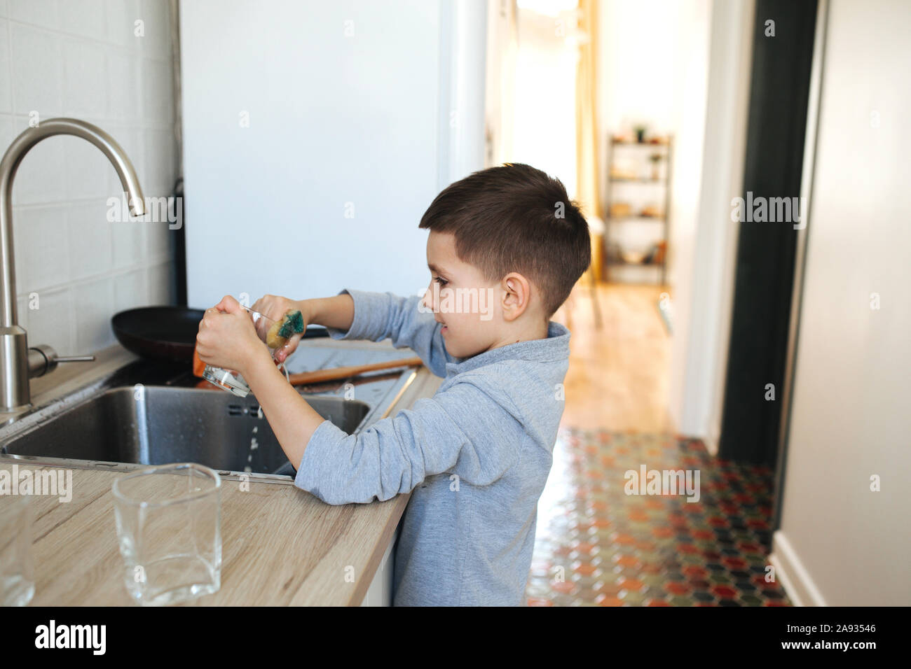 Boy washing dishes hi-res stock photography and images - Alamy