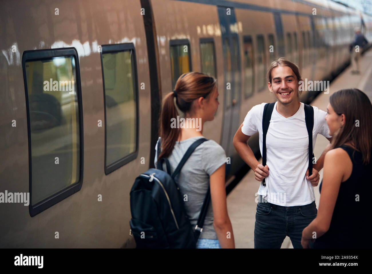 Friends on train station Stock Photo - Alamy