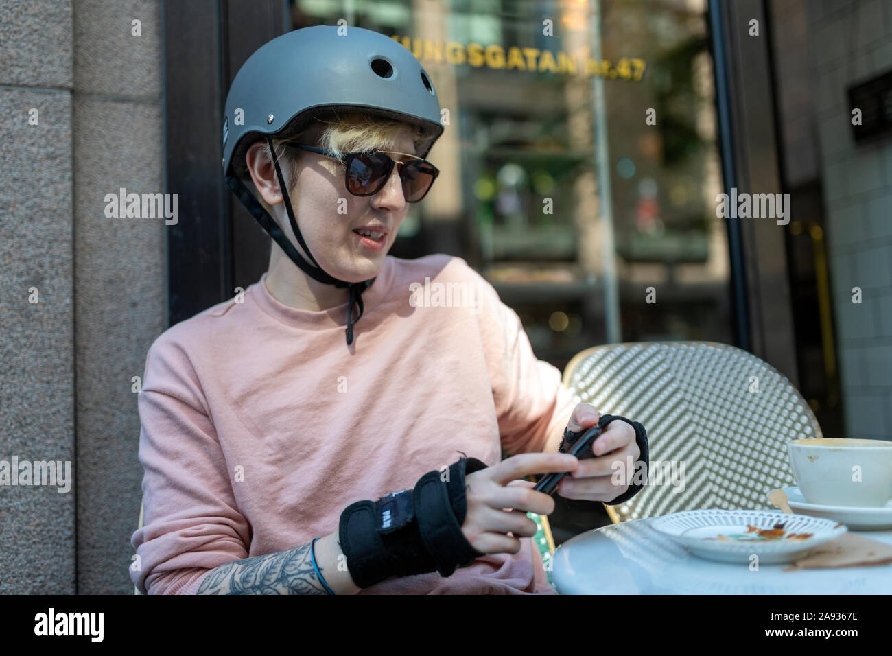 Female skater in outdoor cafe Stock Photo - Alamy