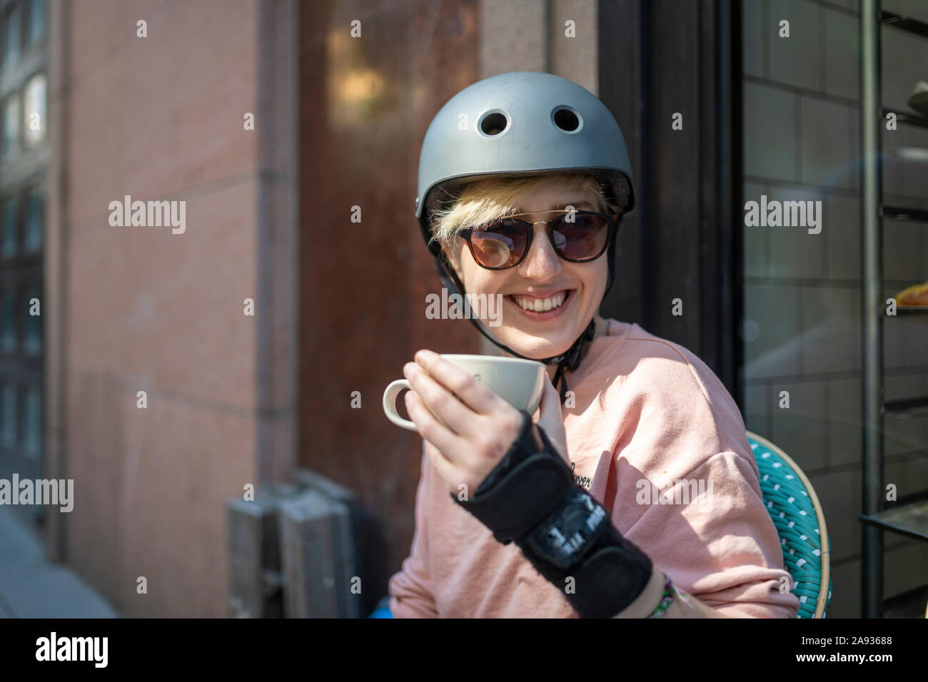 Female skater in outdoor cafe Stock Photo - Alamy
