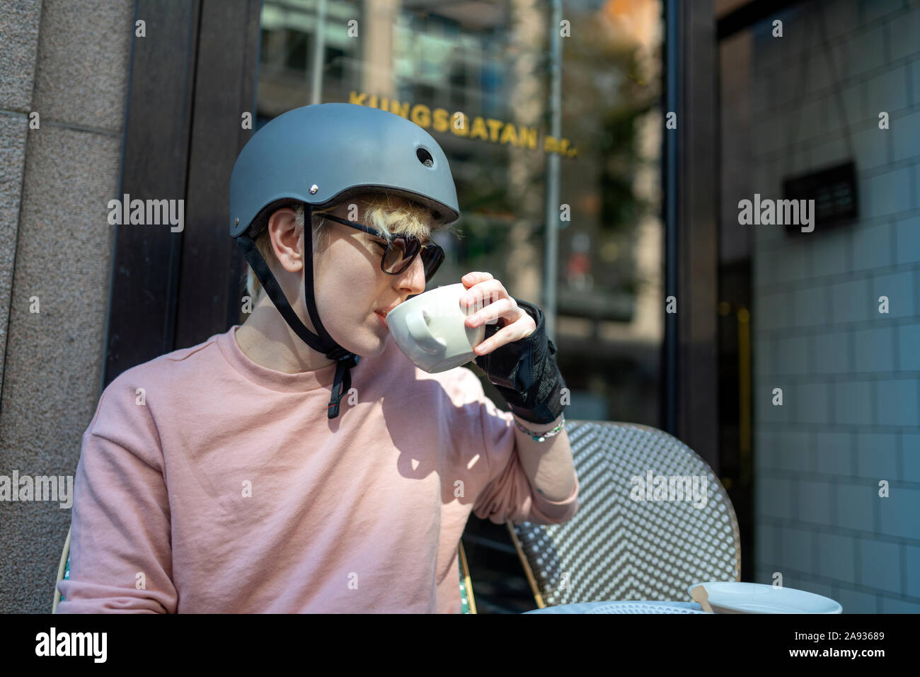 Female skater in outdoor cafe Stock Photo - Alamy