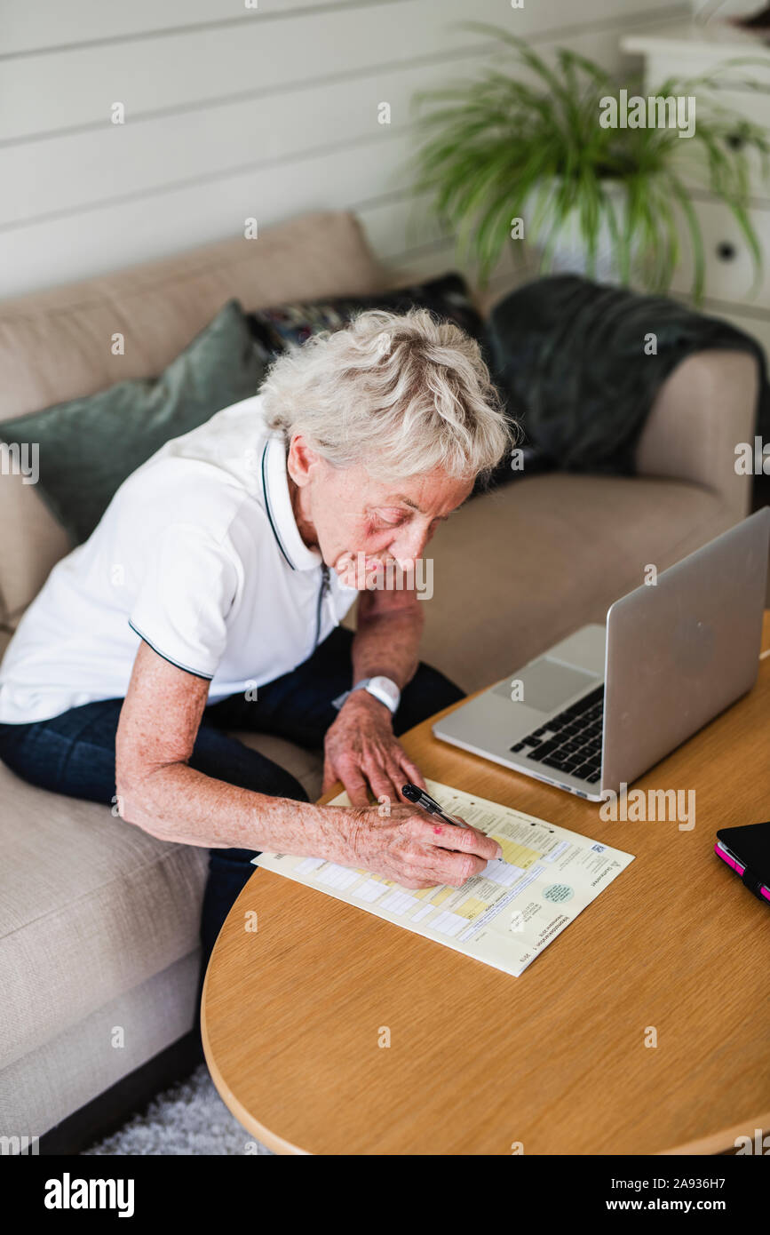 Woman filling documents Stock Photo - Alamy