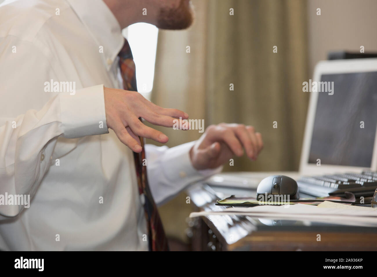 Man with unusual hand working on his computer in an office Stock Photo ...