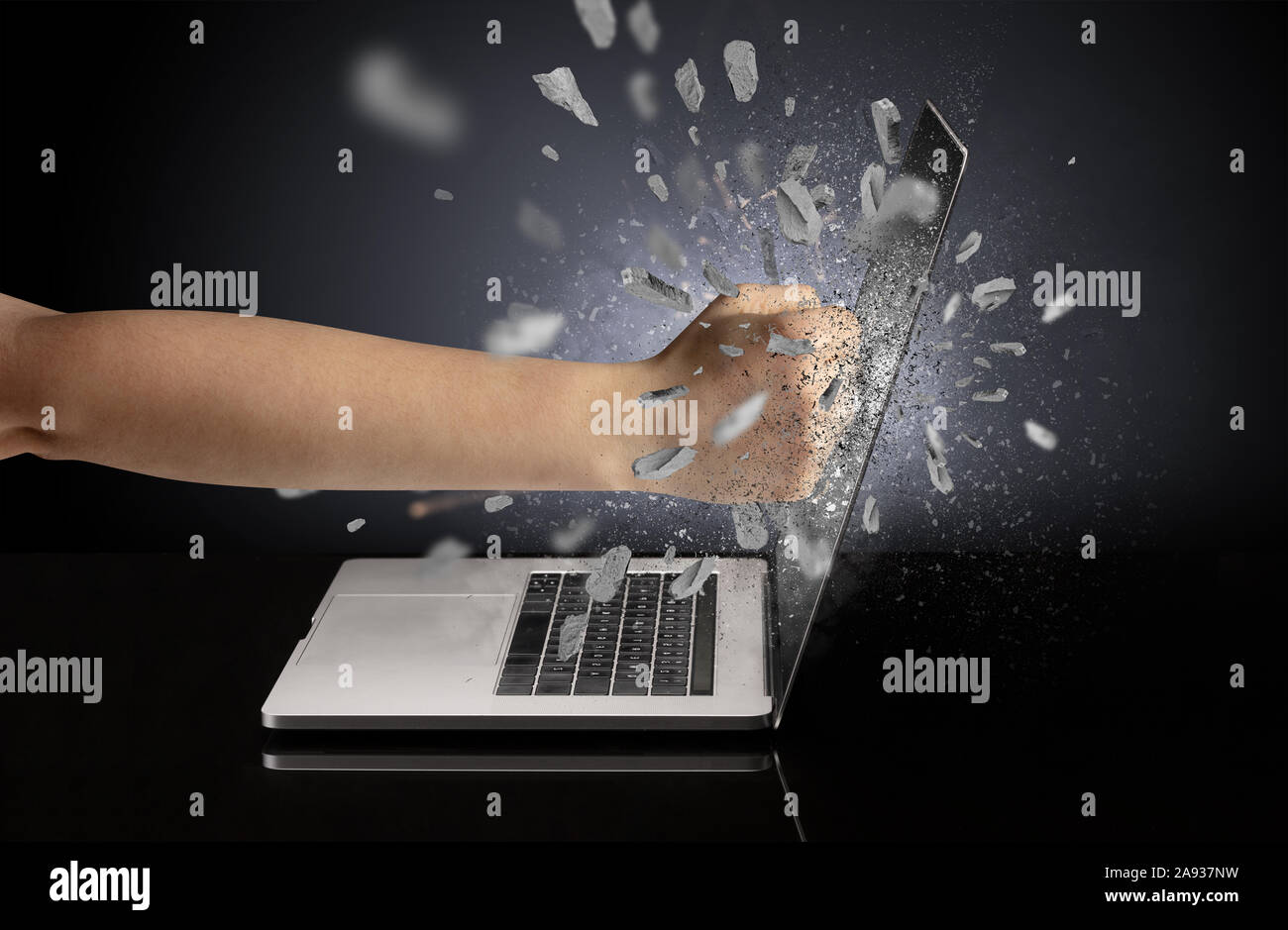 Strong male hand breaks laptop screen Stock Photo - Alamy