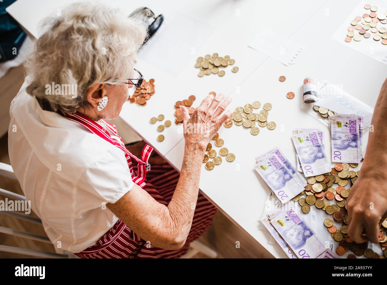 Woman counting coins Stock Photo - Alamy
