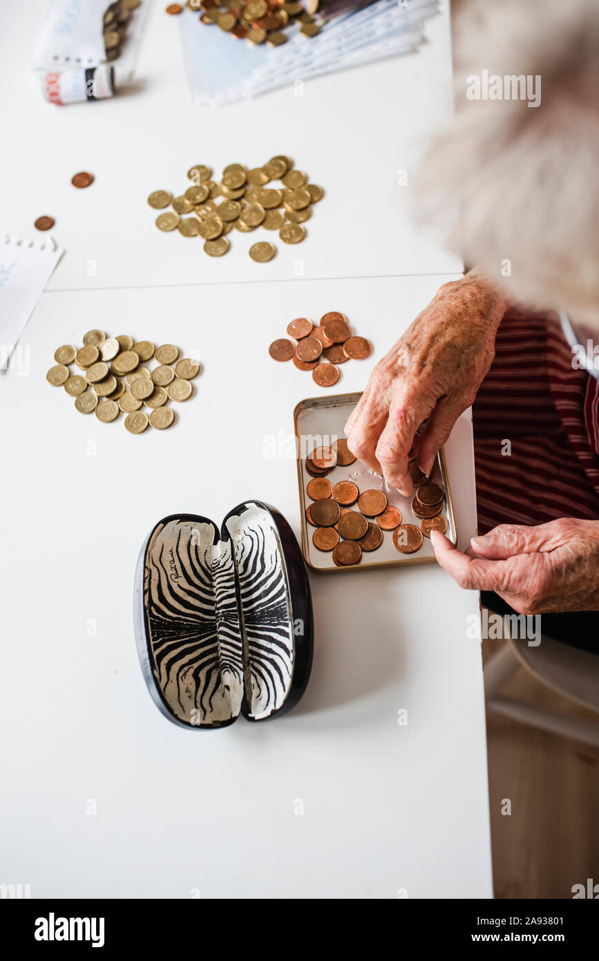 Senior man counting coins hi-res stock photography and images - Alamy