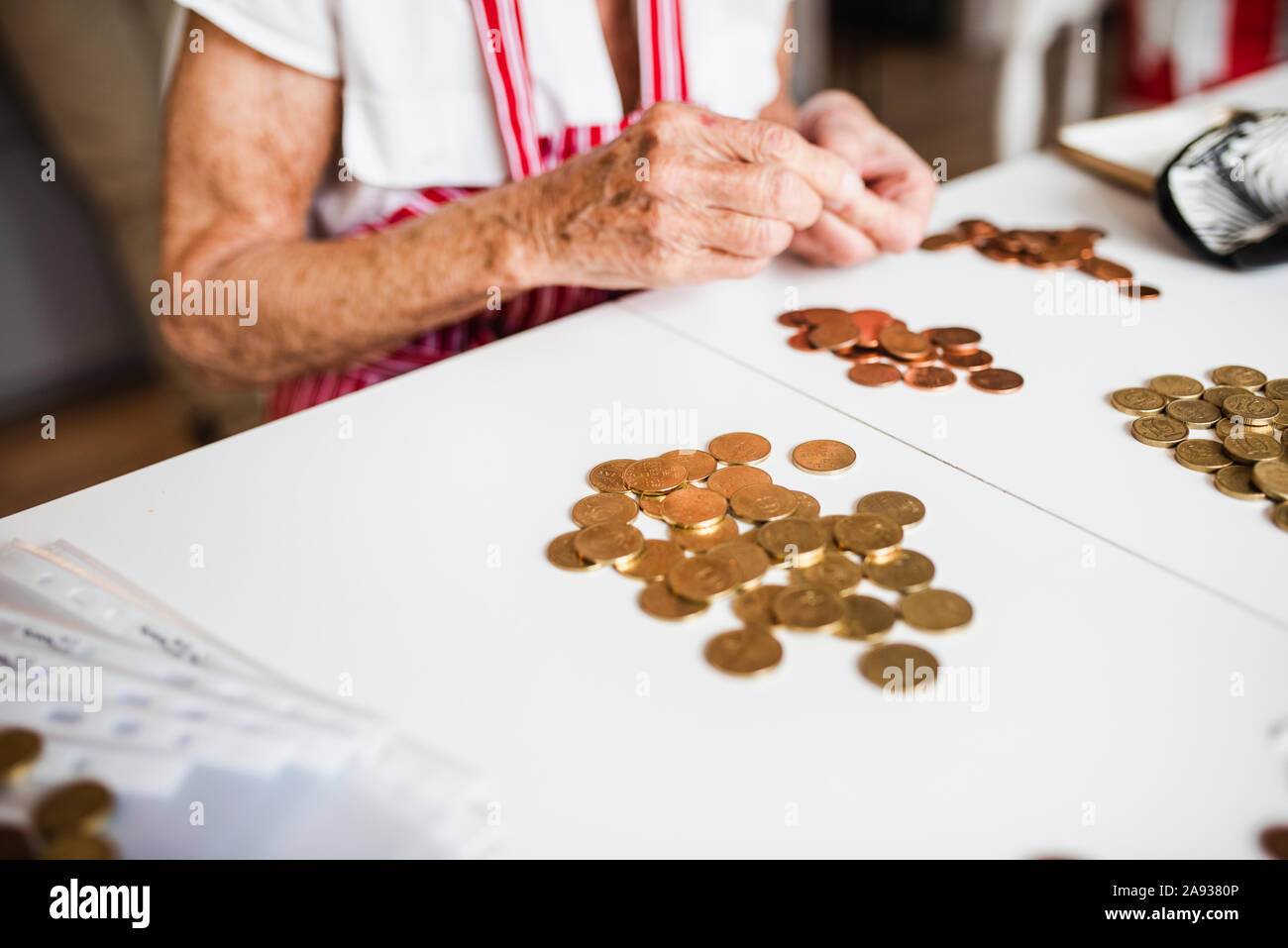 Senior man counting coins hi-res stock photography and images - Alamy