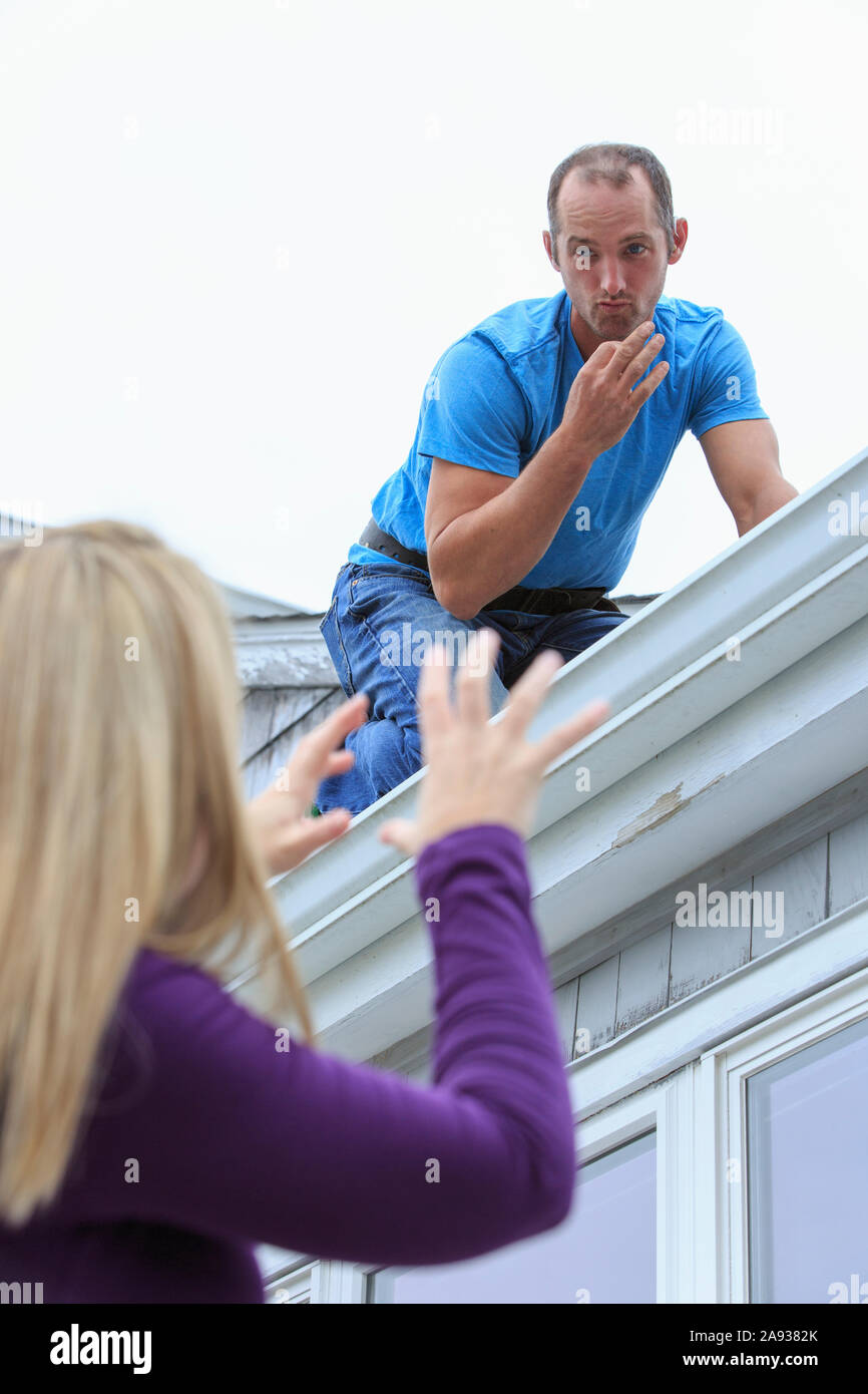 Homeowner and roofer communicating in American Sign Language about ...