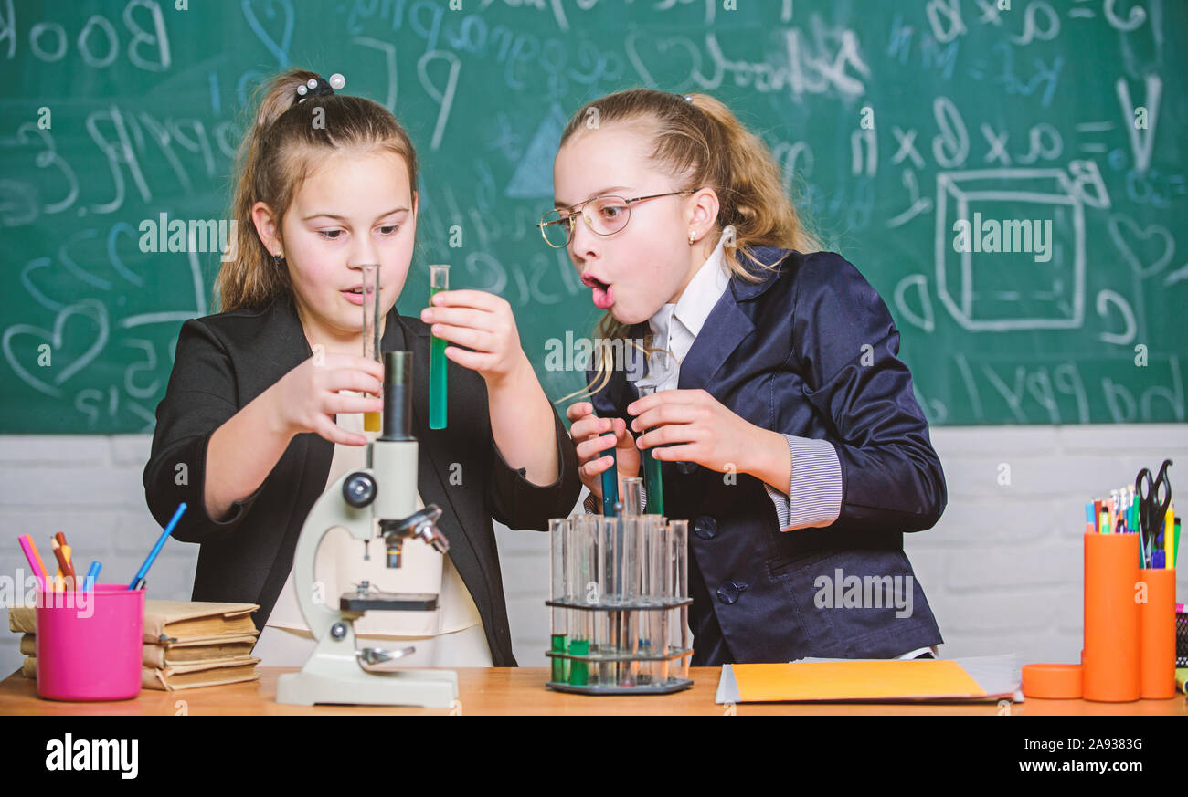 Biology school lesson. Little girls in school lab. Formal school ...