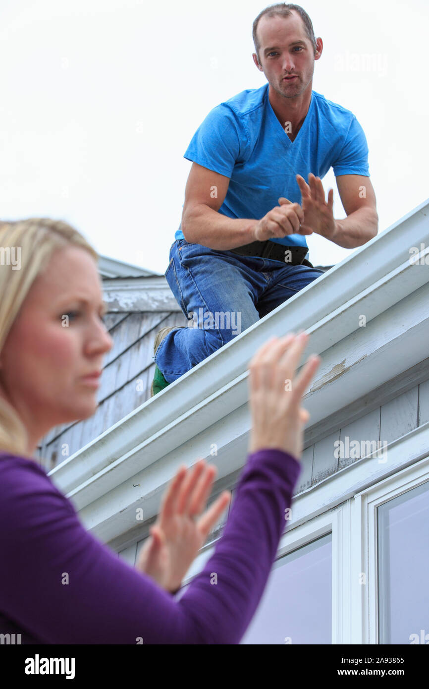 Homeowner and roofer communicating in American Sign Language about ...