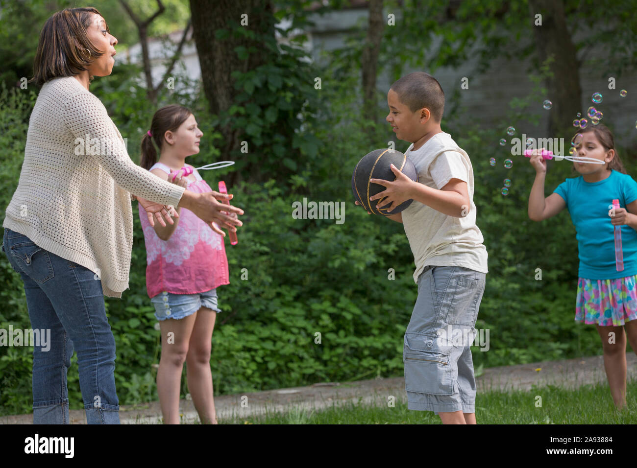 Four children playing outside hi-res stock photography and images - Alamy