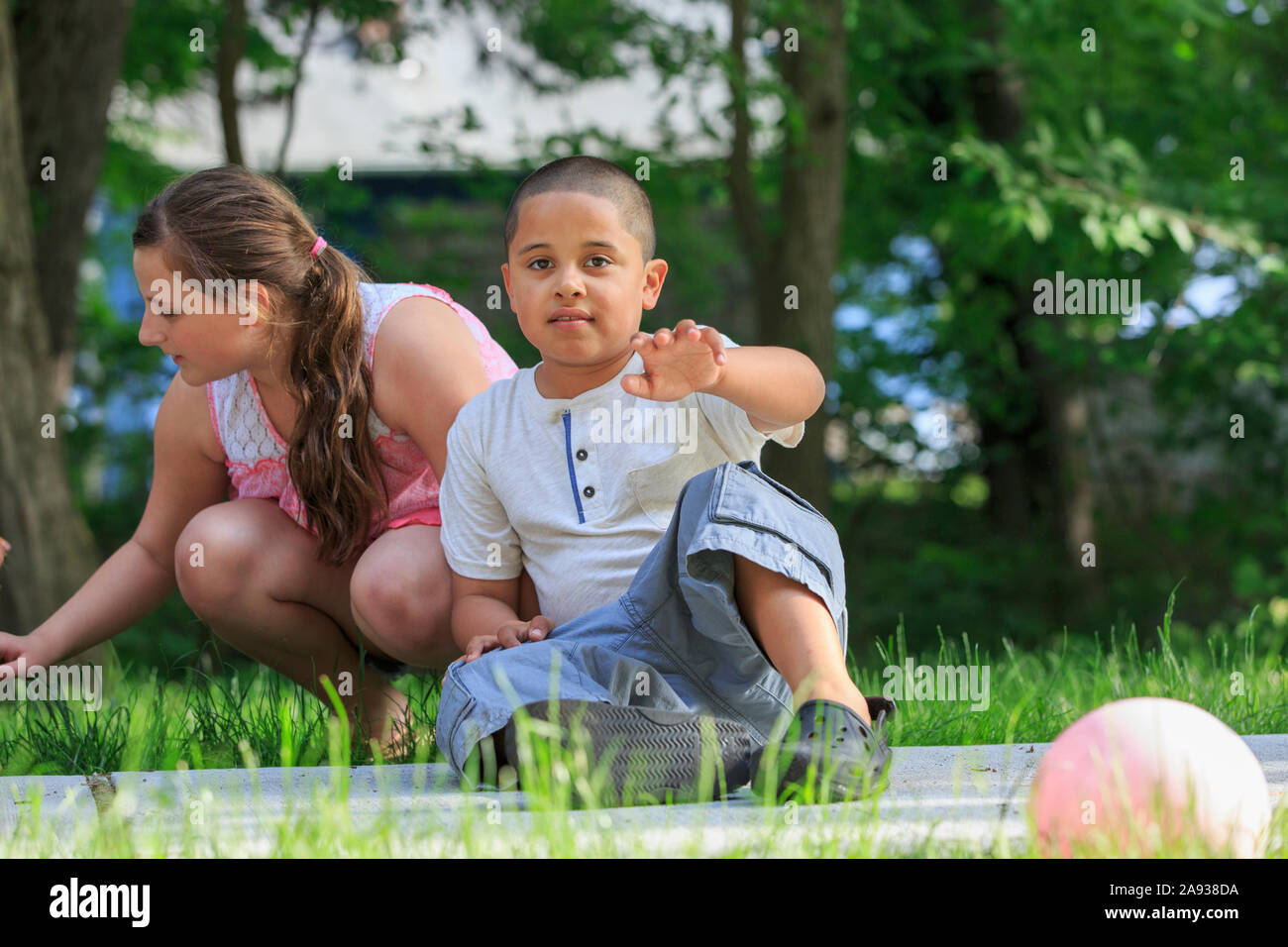 Hispanic boy with Autism playing outside with his sister Stock Photo ...