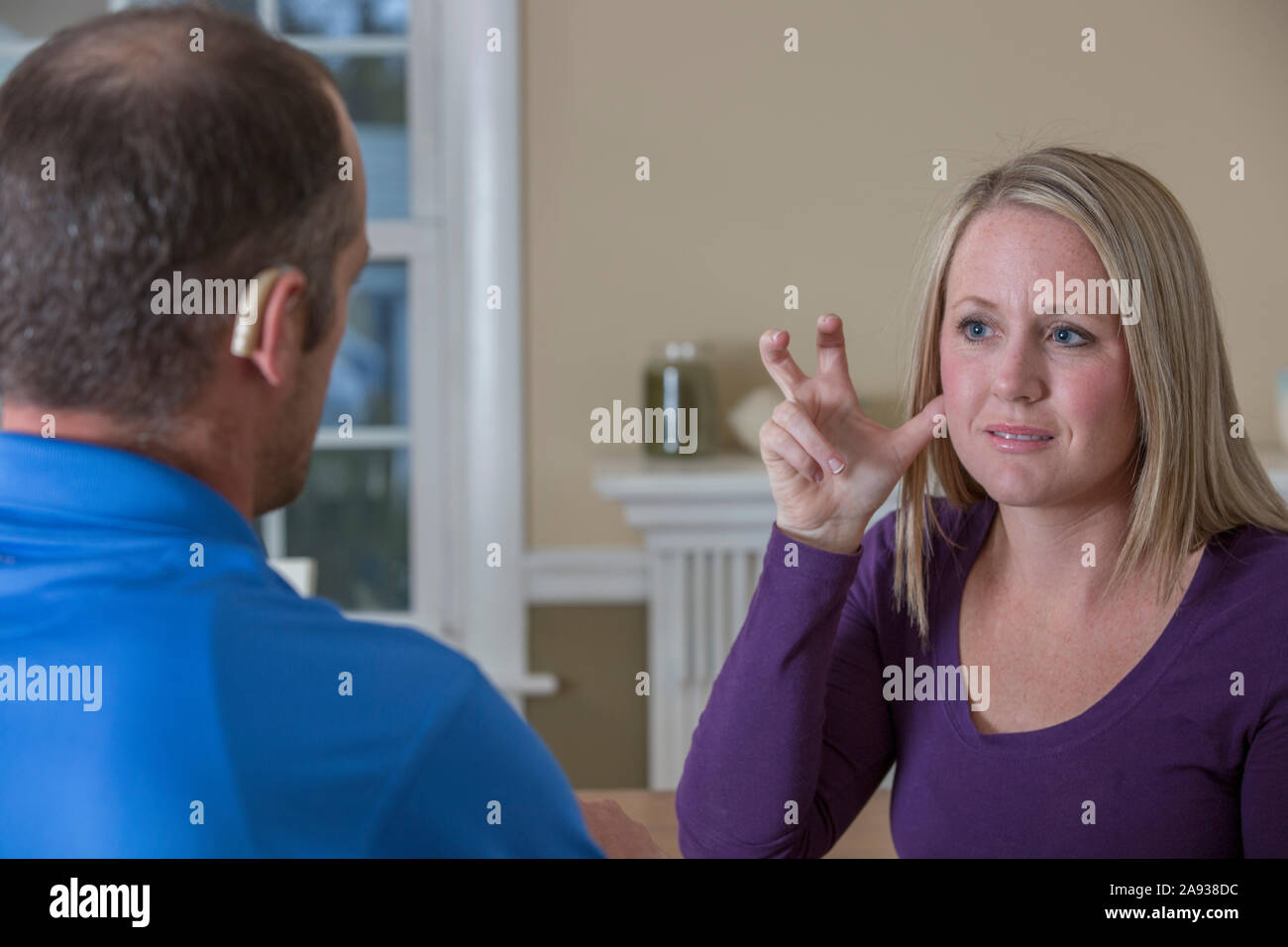 Husband and wife communicating in American Sign Language about 'Hearing ...