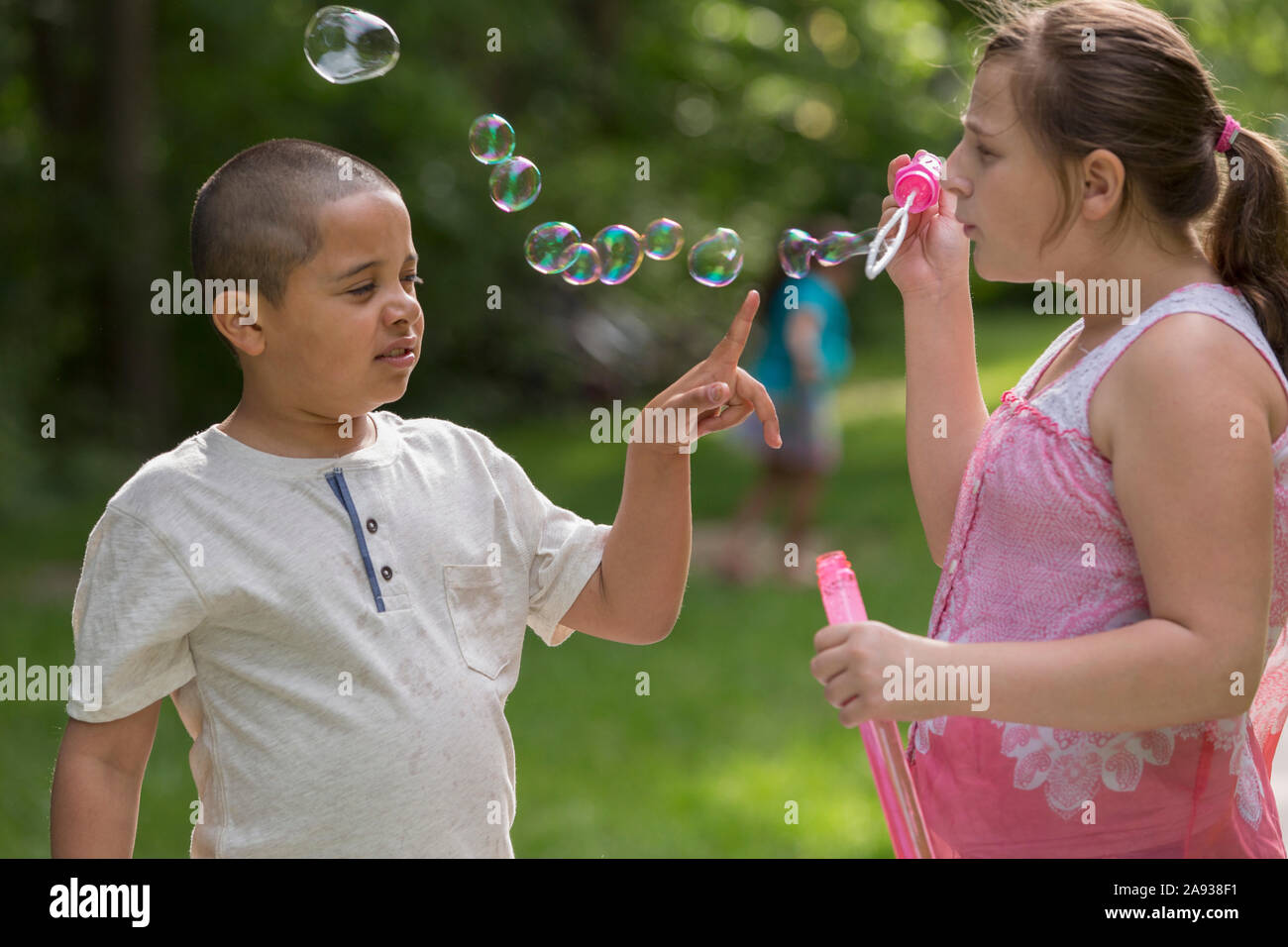 Hispanic boy with Autism playing outside with his sister Stock Photo ...