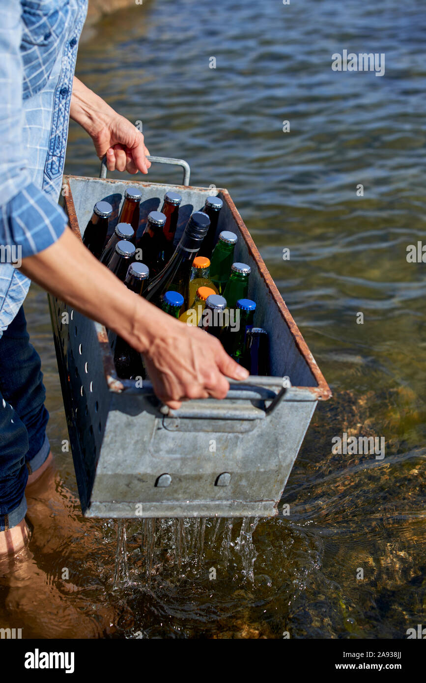 Person holding crate with drinks Stock Photo - Alamy