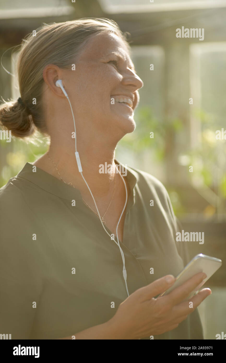 Woman wearing earphones hi-res stock photography and images - Alamy