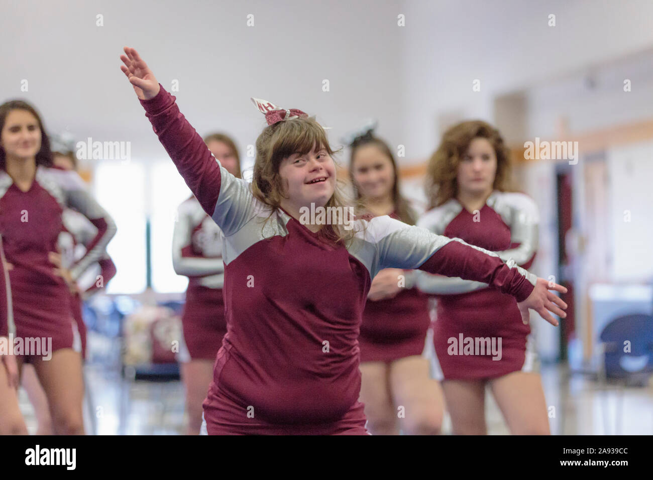 Cheerleader with Down Syndrome cheering with her friends Stock Photo ...