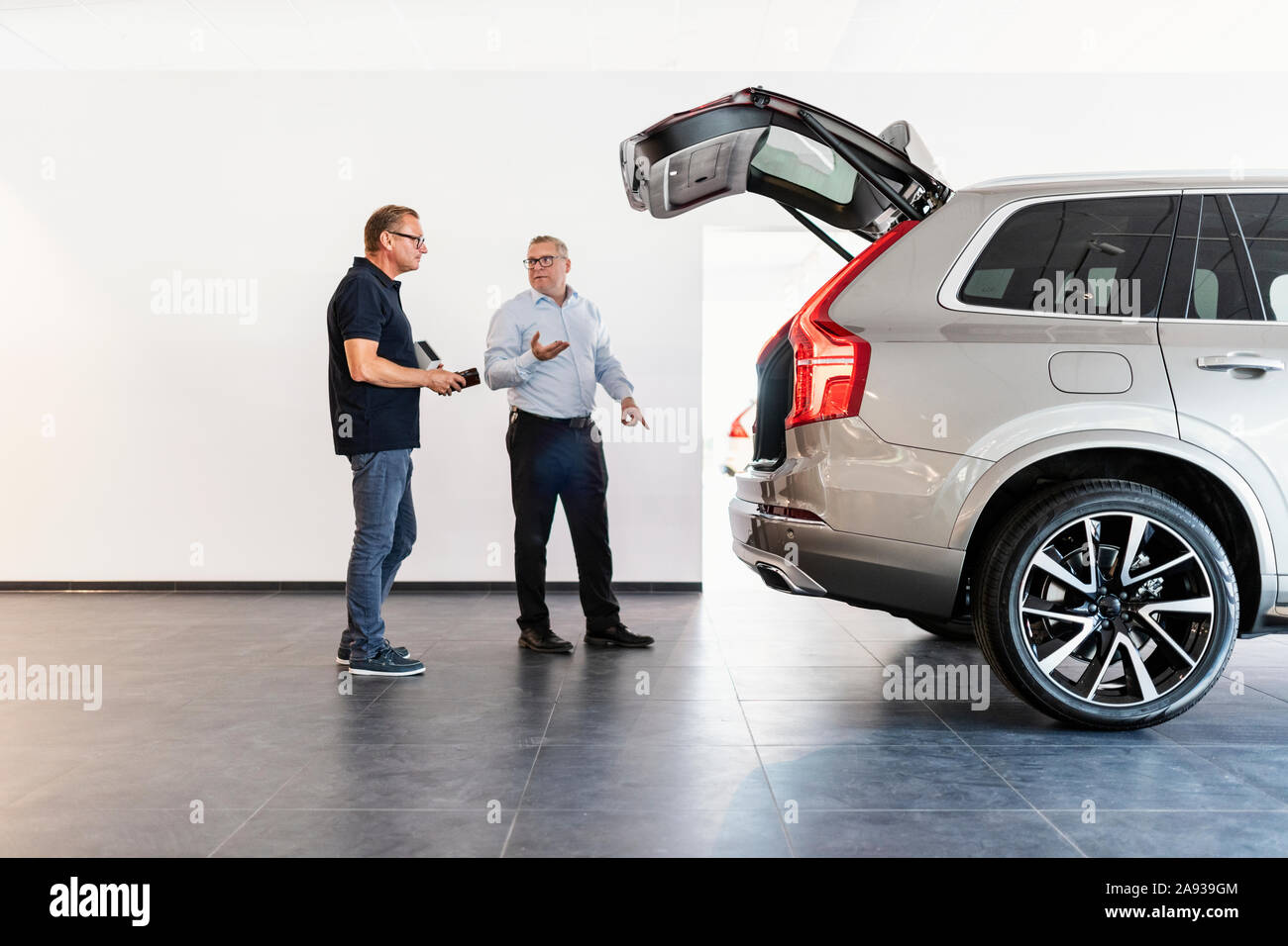 Men in car showroom Stock Photo - Alamy