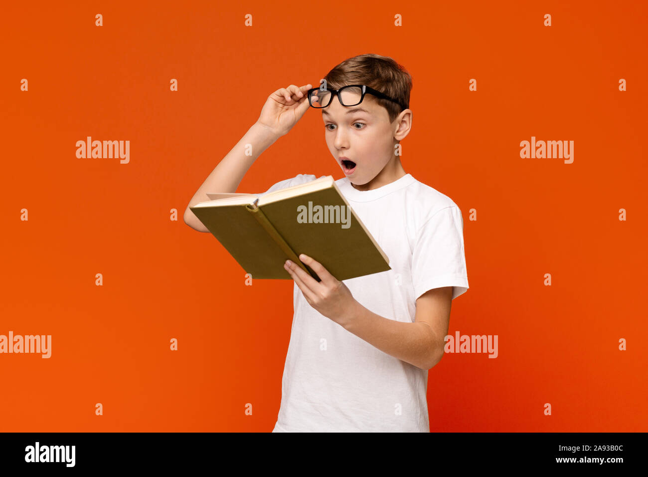 Shocked teen boy surprised by the twists and turn of story Stock Photo ...