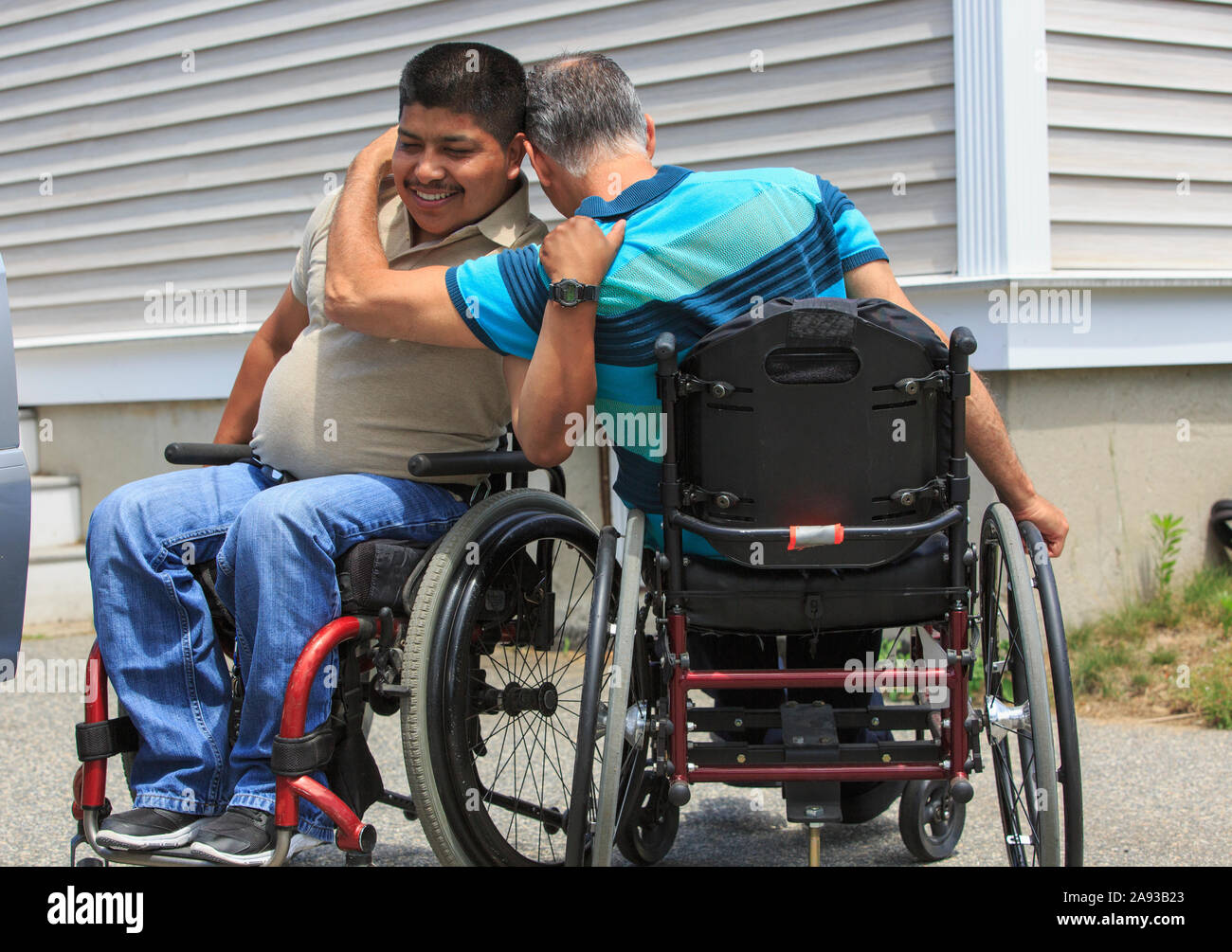 Friends with Spinal Cord Injuries in wheelchairs greeting each other ...