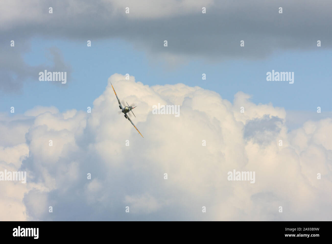 Front view of a Supermarine Spitfire emerging from the clouds. England ...