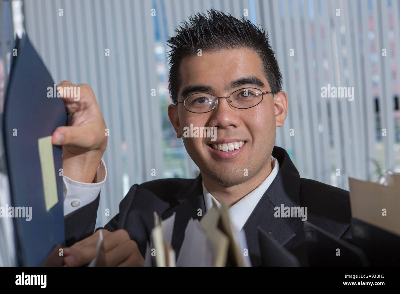 Portrait of Asian man with Autism working in an office Stock Photo - Alamy