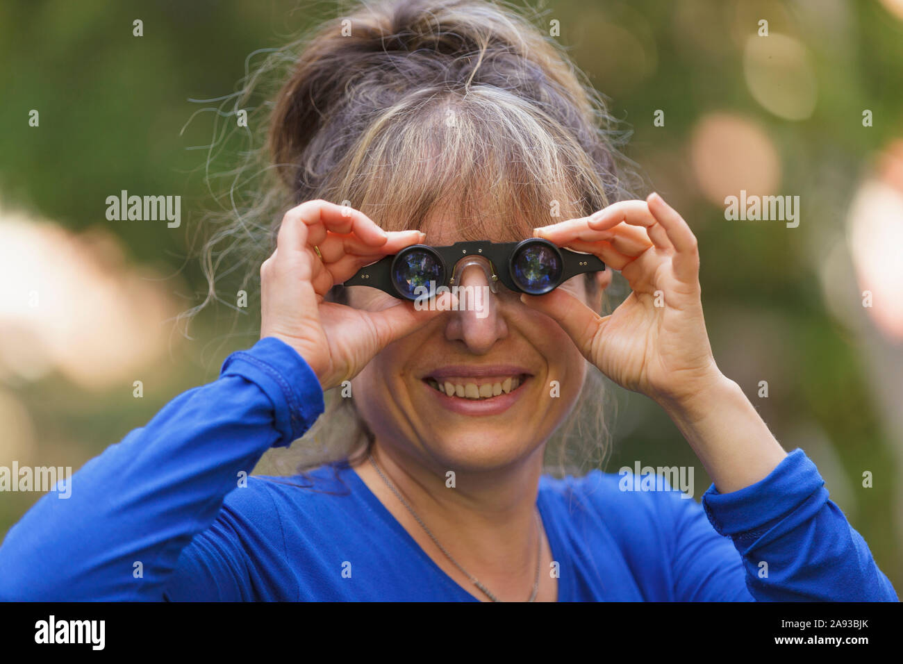 Woman with visual impairment using special glasses to see in park Stock ...