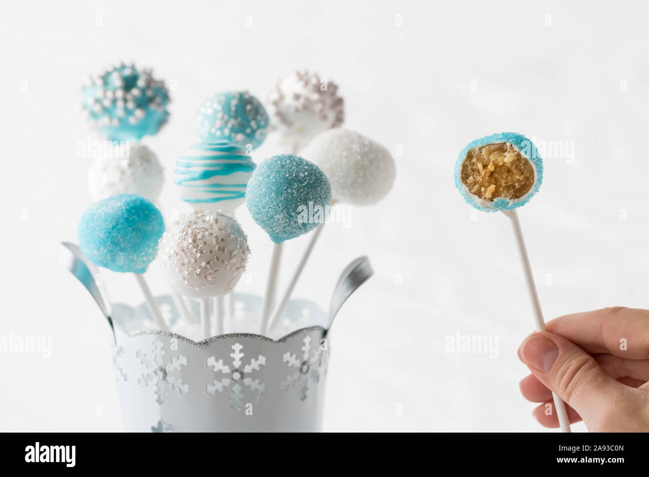 Blue and white cake pops with hand Stock Photo - Alamy