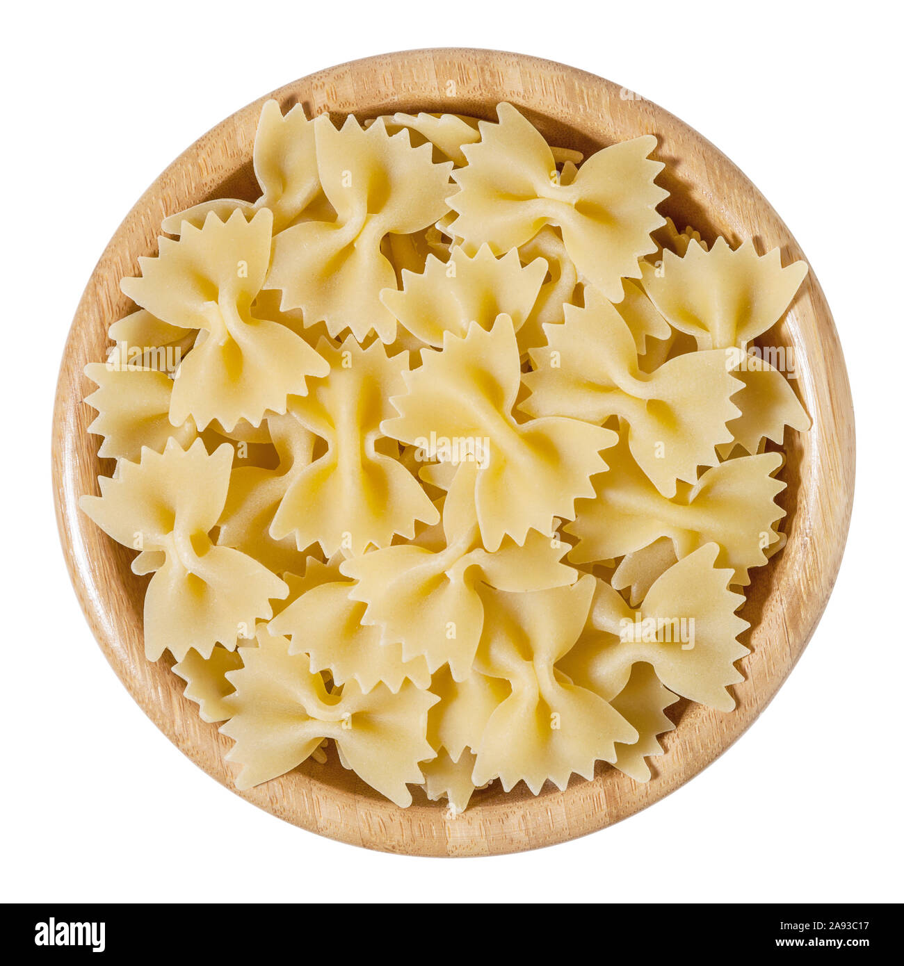 Dry bow tie pasta in wooden bowl isolated on white background with ...