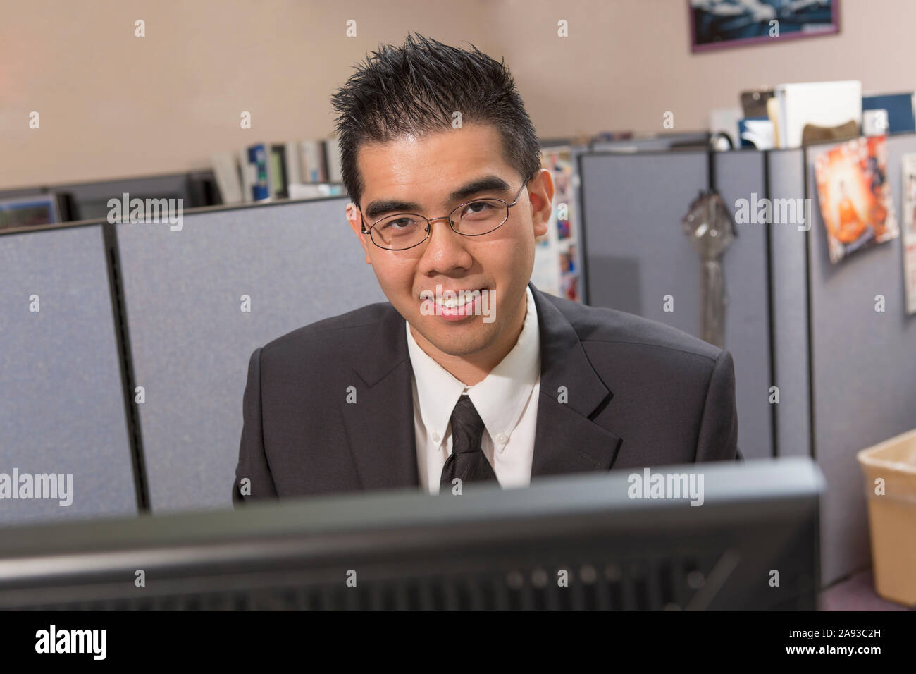 Portrait of happy Asian man with Autism working on computer in an ...
