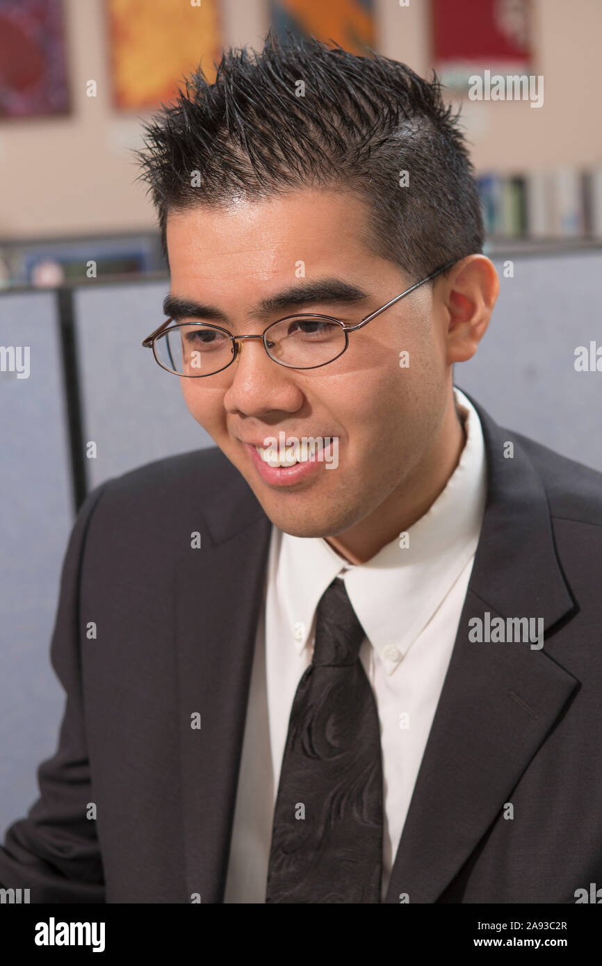 Happy Asian man with Autism working in an office Stock Photo - Alamy