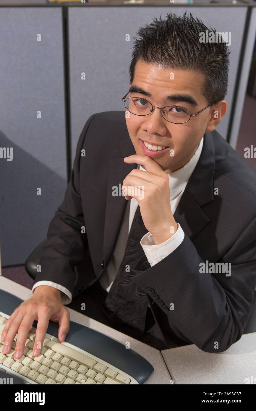 Happy Asian man with Autism working on computer in an office Stock ...