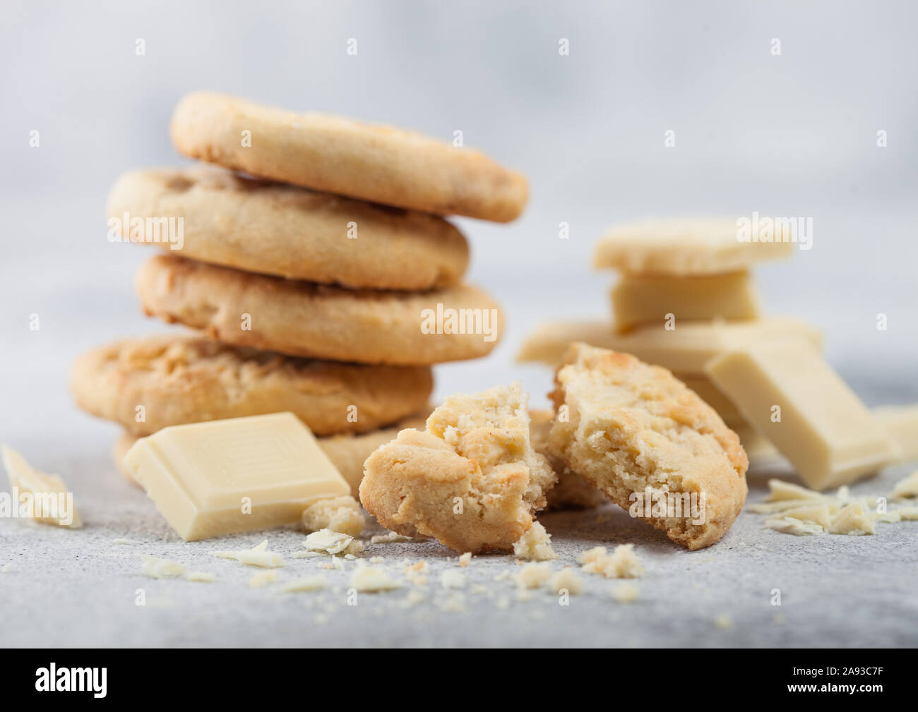 White chocolate biscuit cookies with chocolate blocks and curls on ...