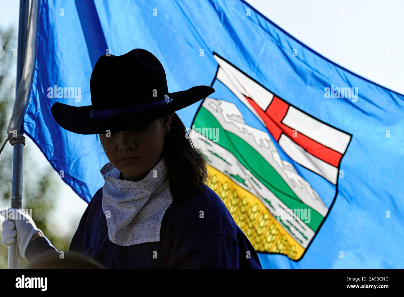 Cowgirl holding an Alberta flag during the Calgary Stampede Parade ...