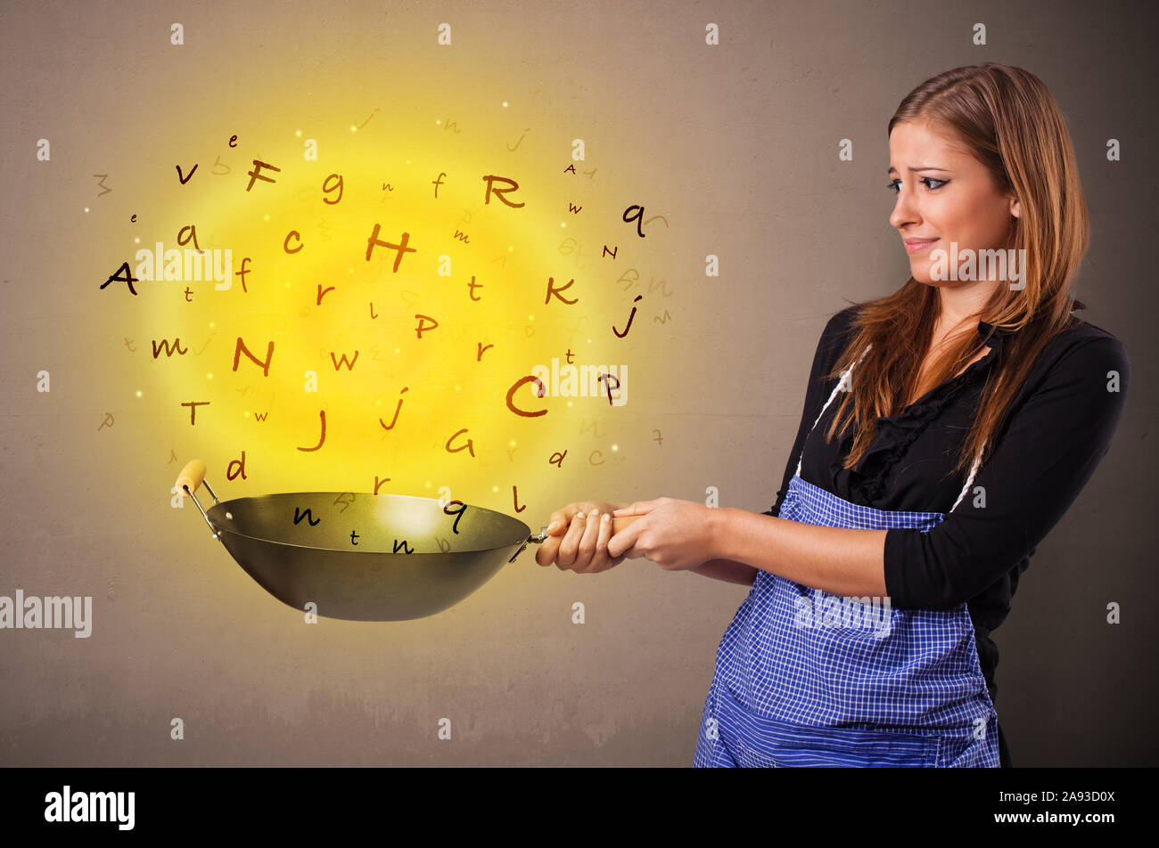 Young person cooking letters in wok Stock Photo - Alamy