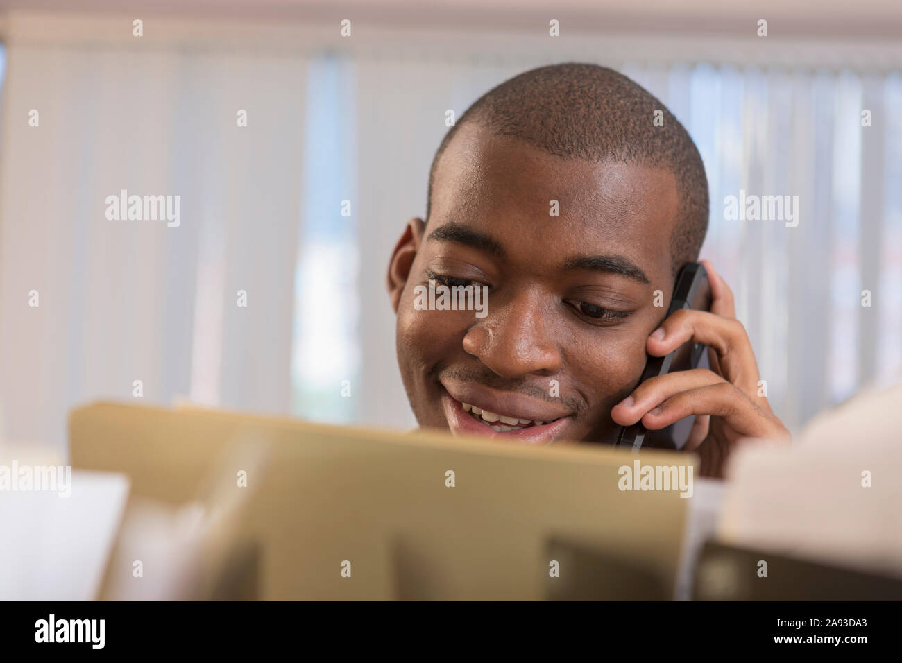 Happy African American man with Autism talking on cell phone while ...