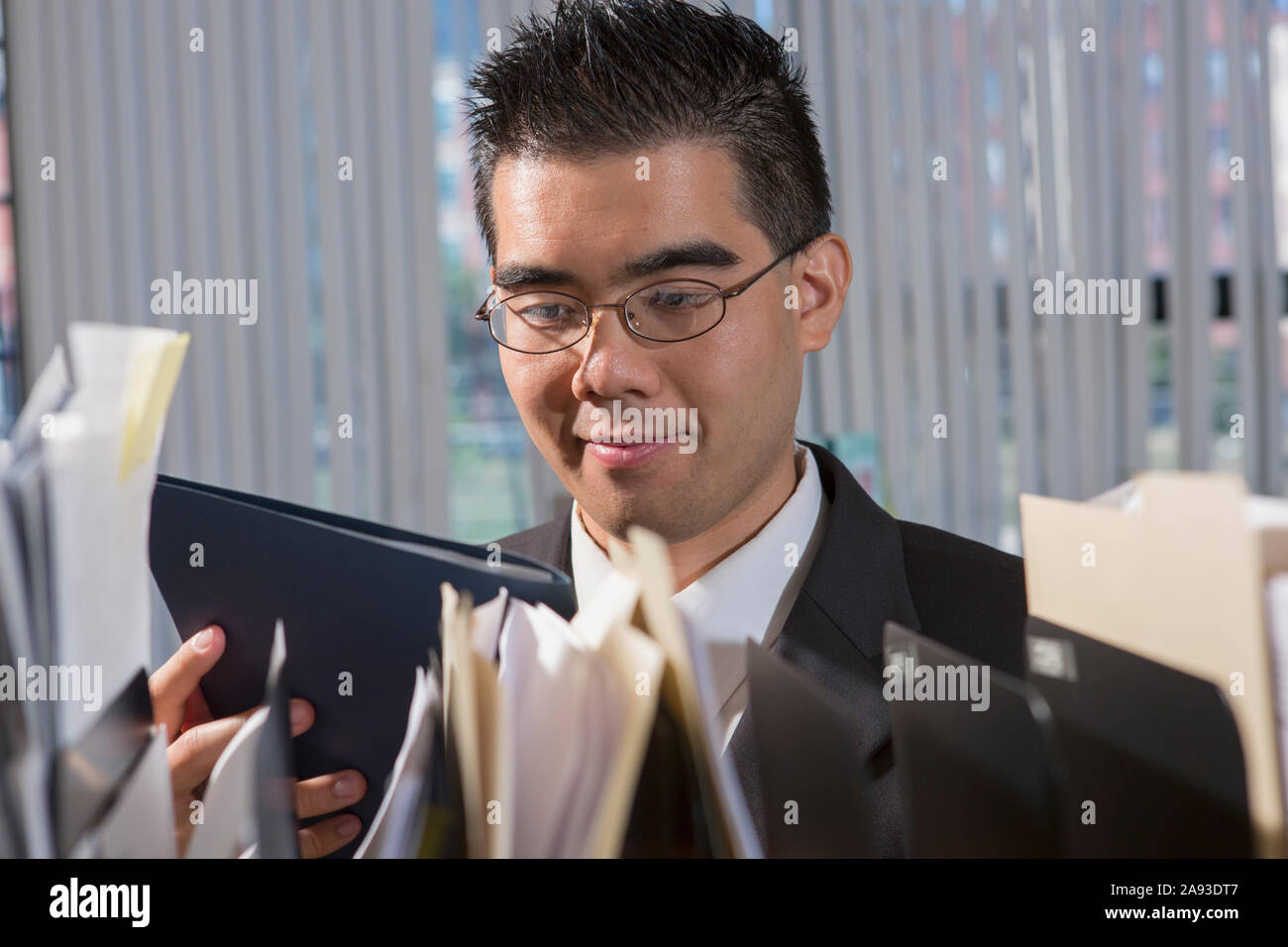 Asian man with Autism working in an office Stock Photo - Alamy