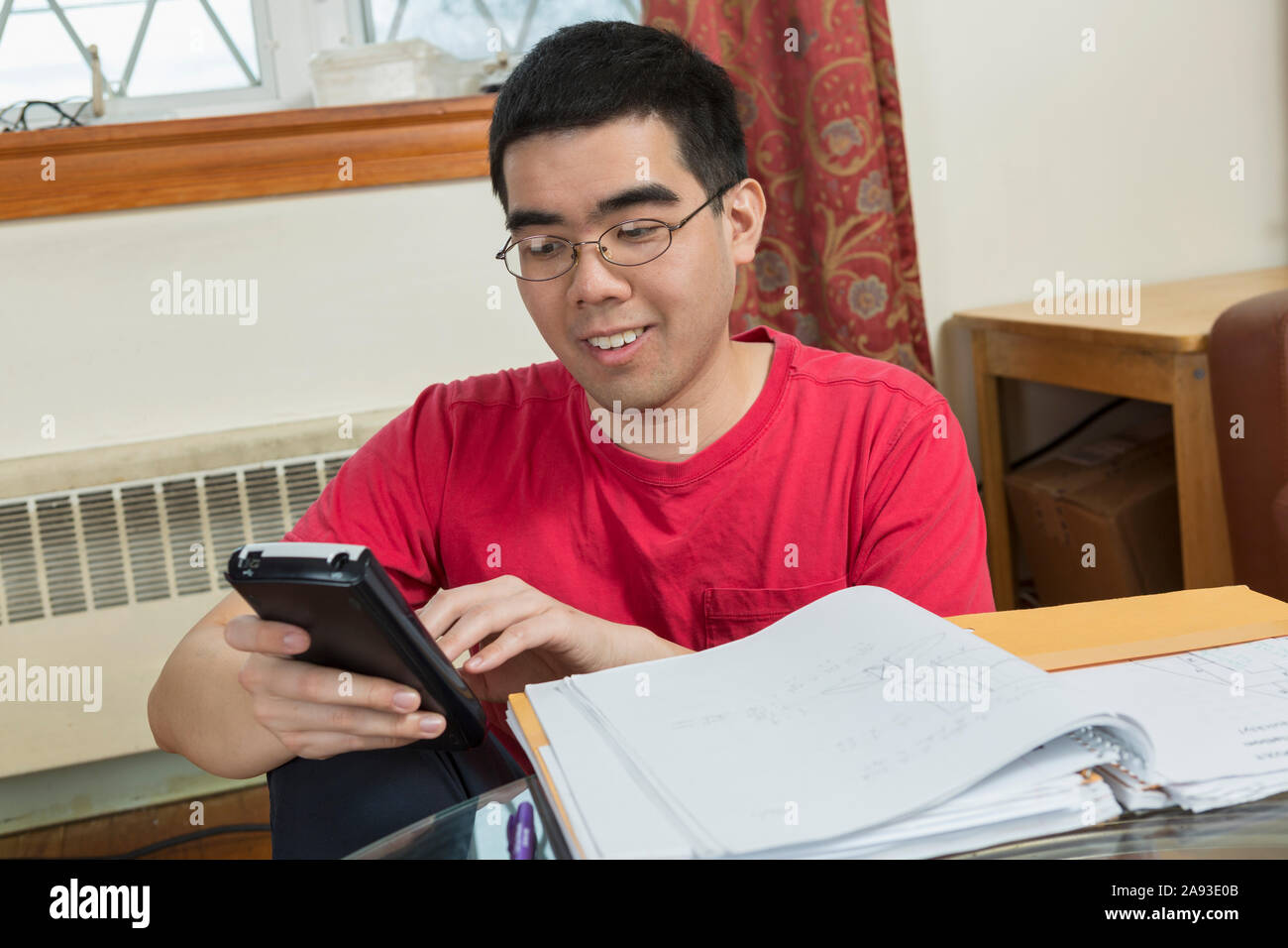 Happy Asian man with Autism using a phone Stock Photo - Alamy