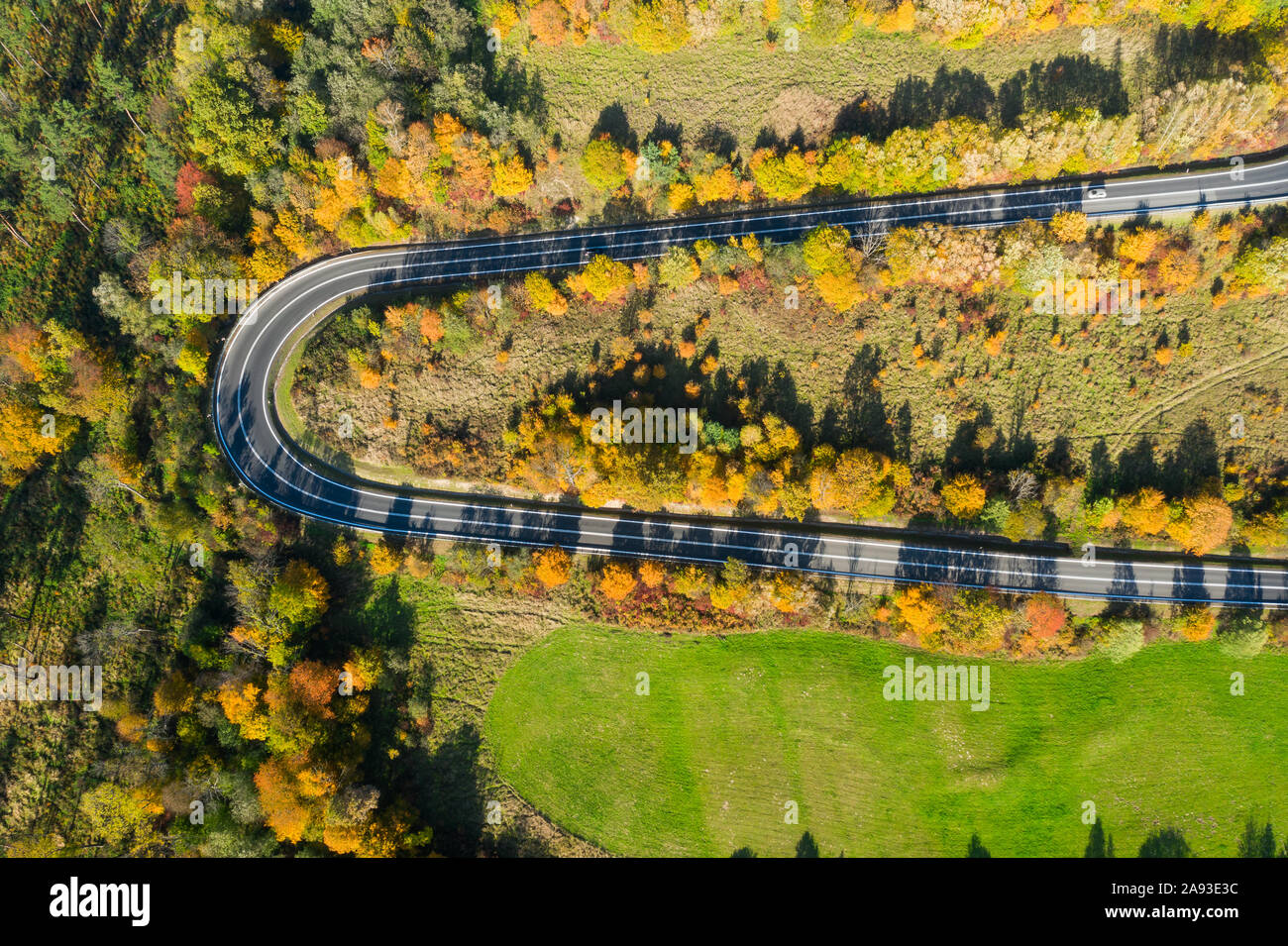 Drone view - Aerial view of autumn forest road. Top view of beautiful ...