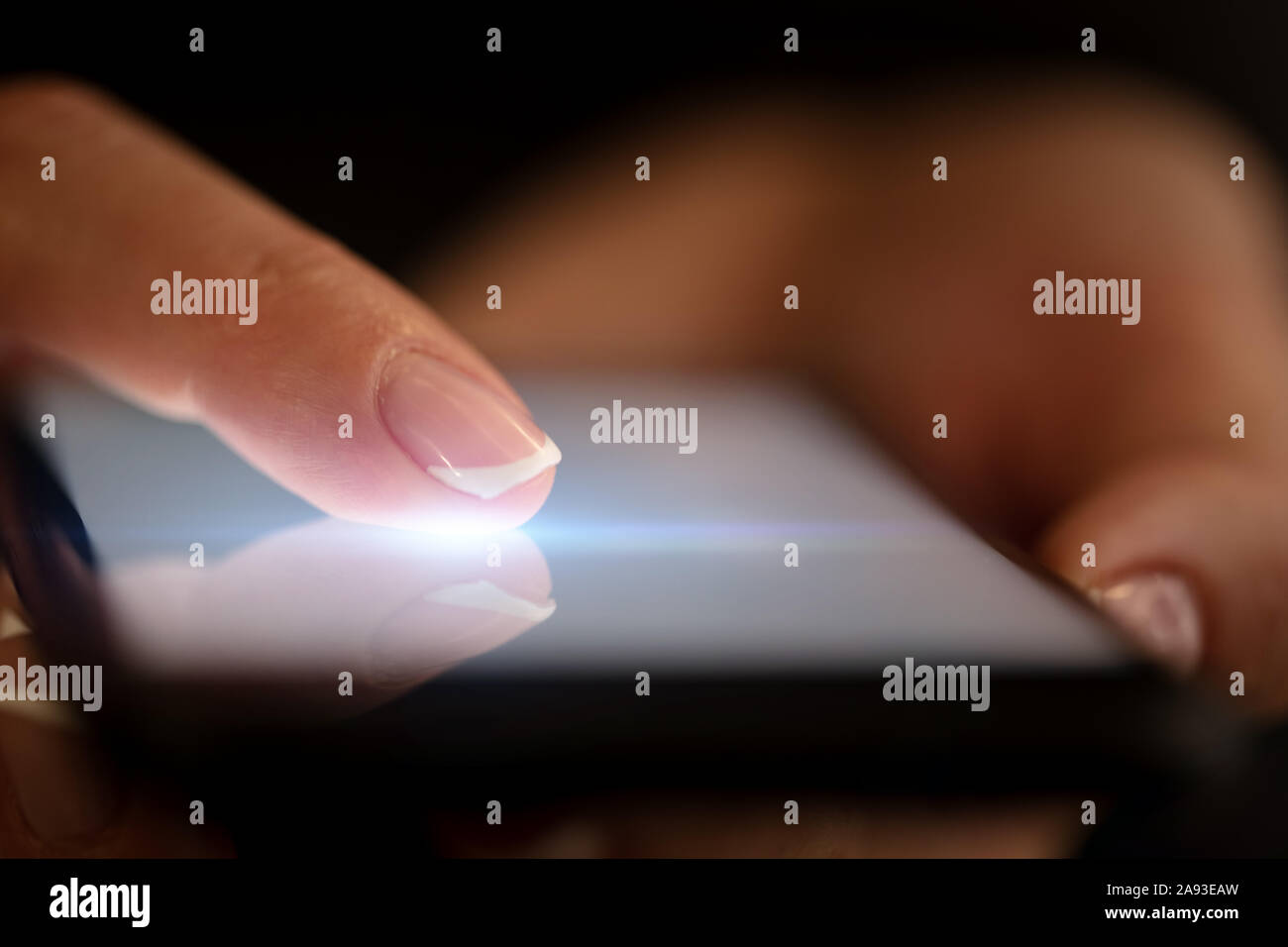 Finger touching phone with dark background with copyspace Stock Photo ...