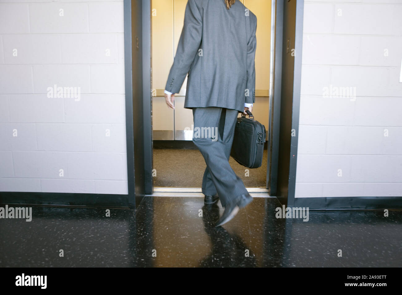 A man stepping into an elevator Stock Photo - Alamy