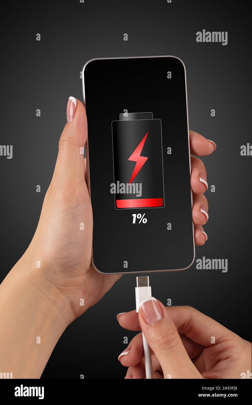 Elegant hand charging cellphone with low battery Stock Photo - Alamy