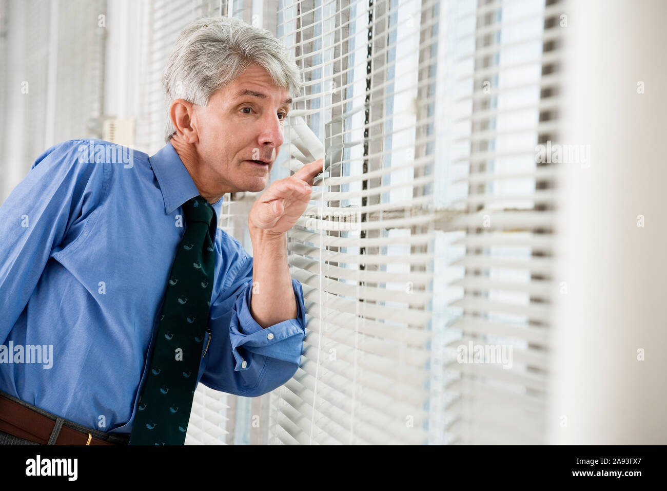 A business man looking out from his office window Stock Photo - Alamy